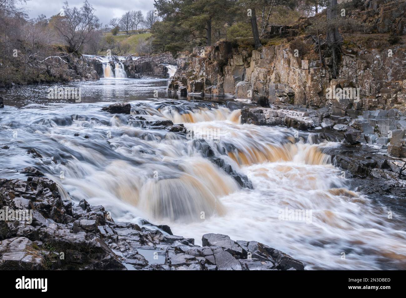 A fast flowing River Tees drops over multiple falls in northern England ...