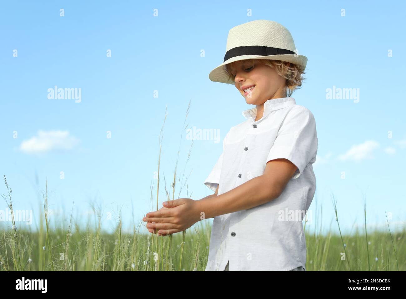 Cute little boy wearing stylish hat outdoors. Child spending time in ...