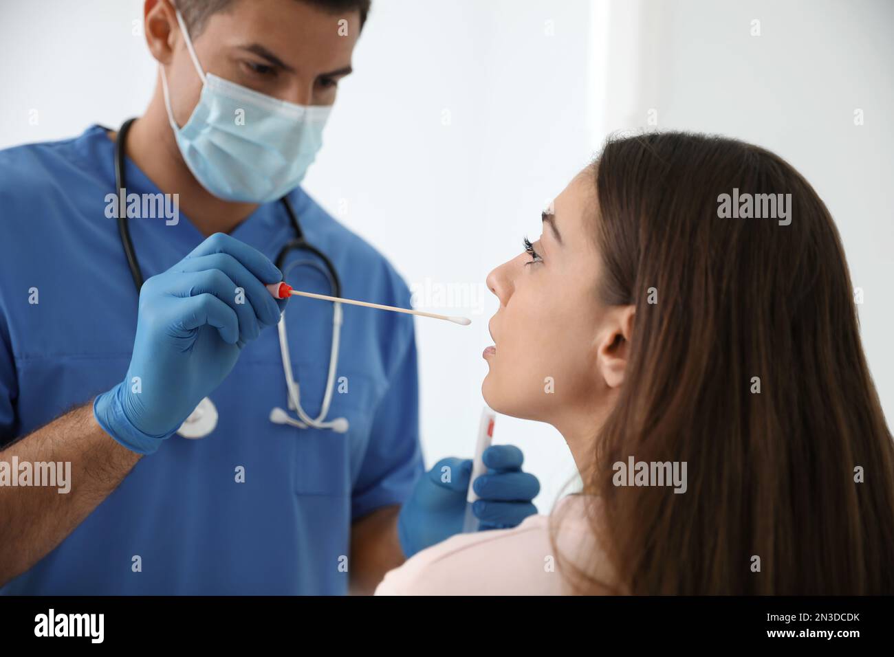 Doctor taking sample for DNA test from woman in clinic Stock Photo - Alamy