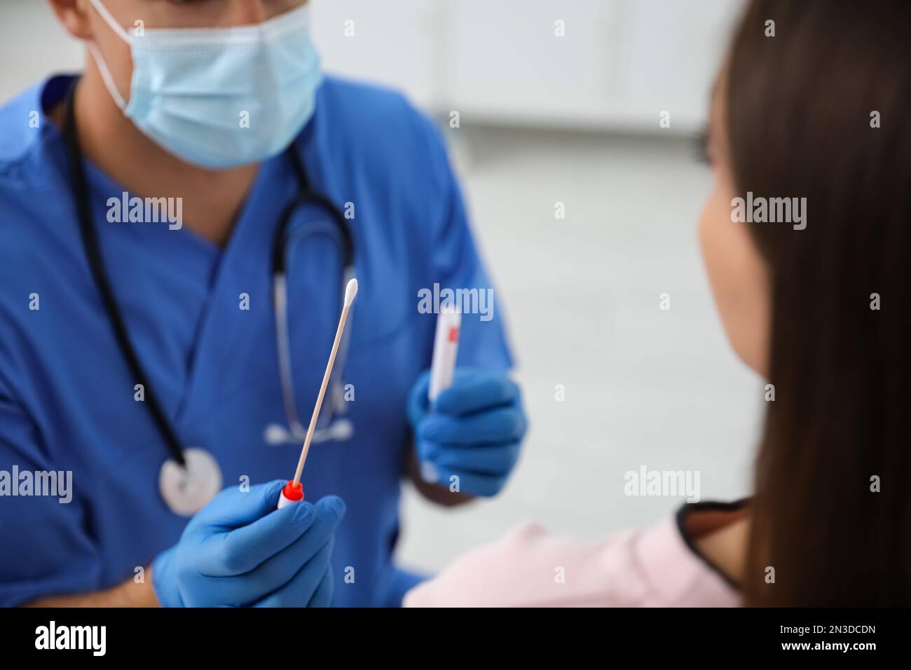 Doctor taking sample for DNA test from woman in clinic Stock Photo - Alamy