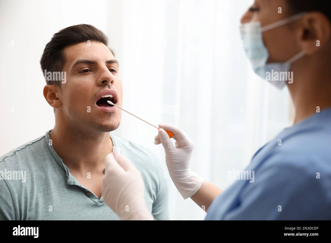 Doctor taking sample for DNA test from man in clinic Stock Photo - Alamy