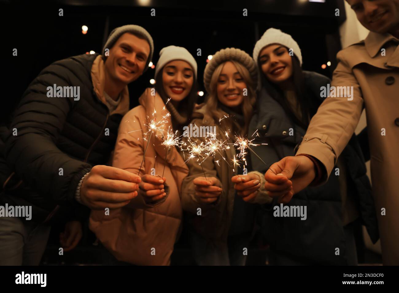 Group of people holding burning sparklers, focus on hands Stock Photo ...