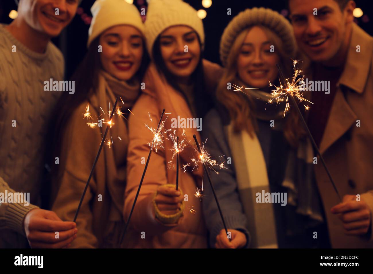 Group of people holding burning sparklers, focus on fireworks Stock ...