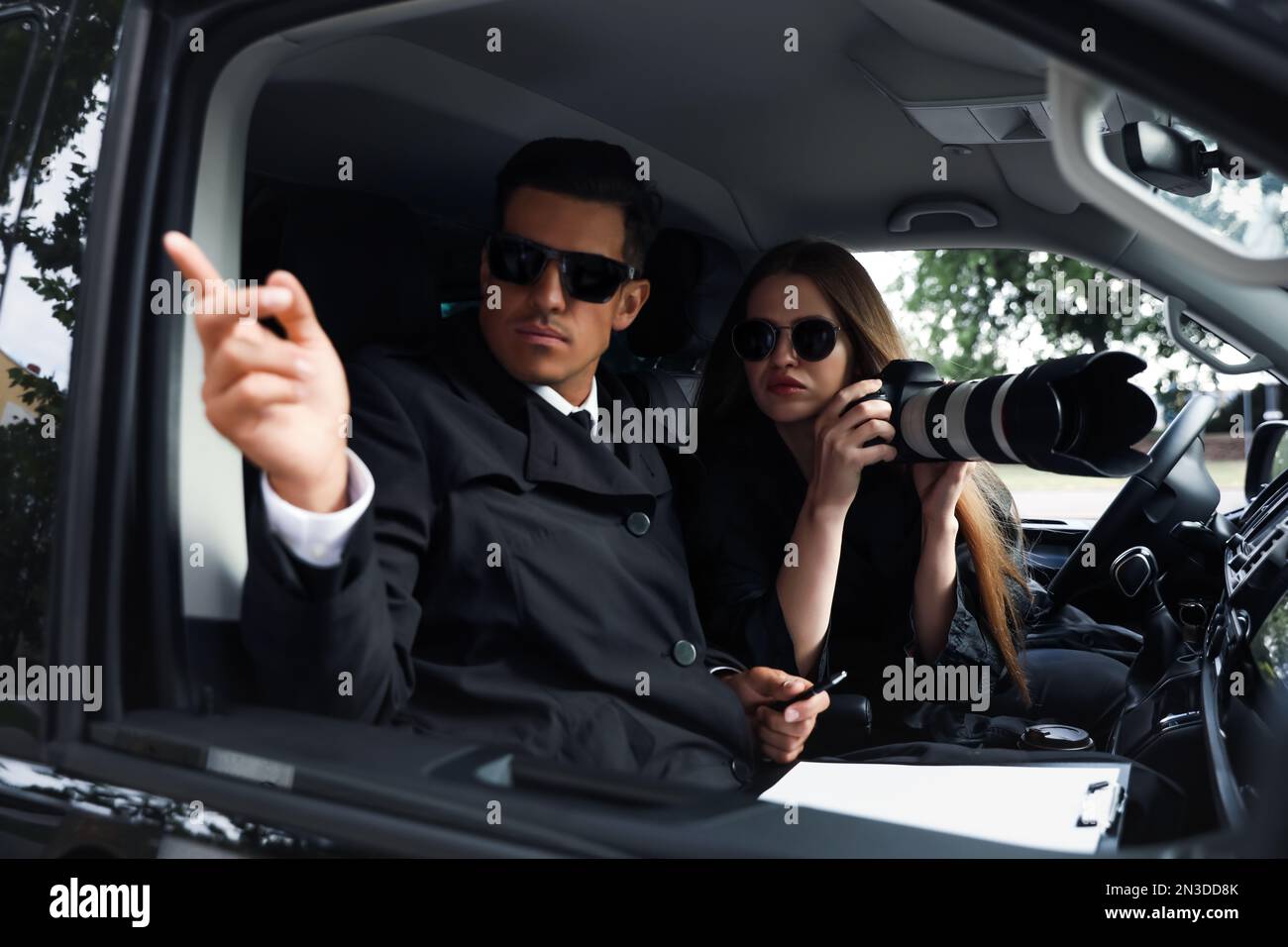 Private detectives with modern camera spying from car Stock Photo - Alamy