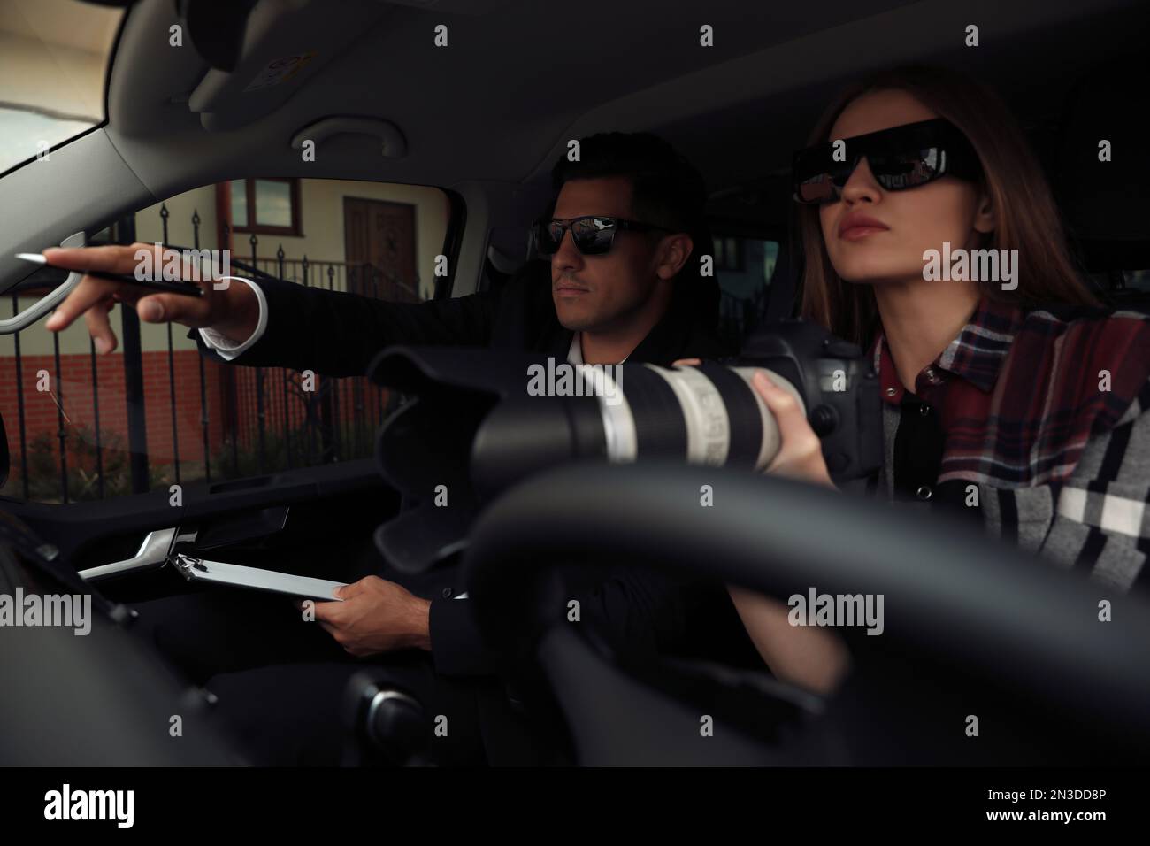 Private detectives with modern camera spying from car Stock Photo - Alamy