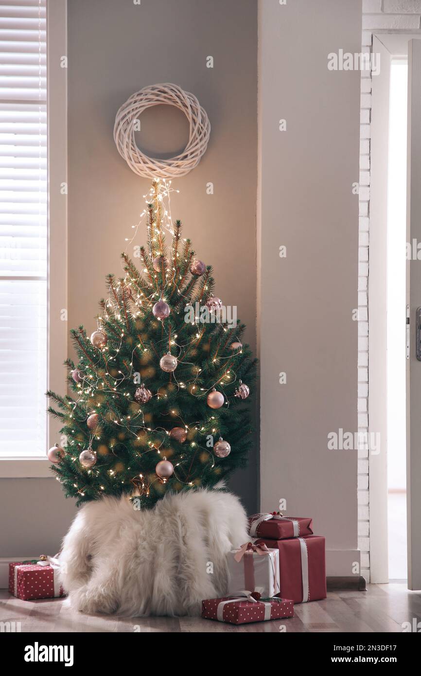 Christmas tree and gift boxes near window in room. Festive interior ...