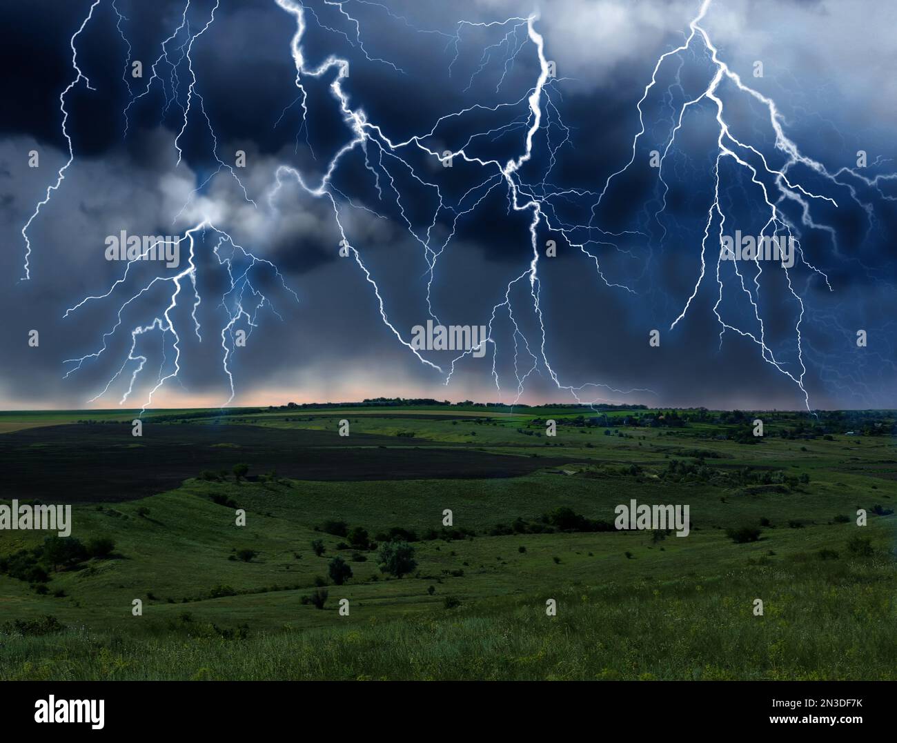 Dark cloudy sky with lightnings. Picturesque thunderstorm over field ...