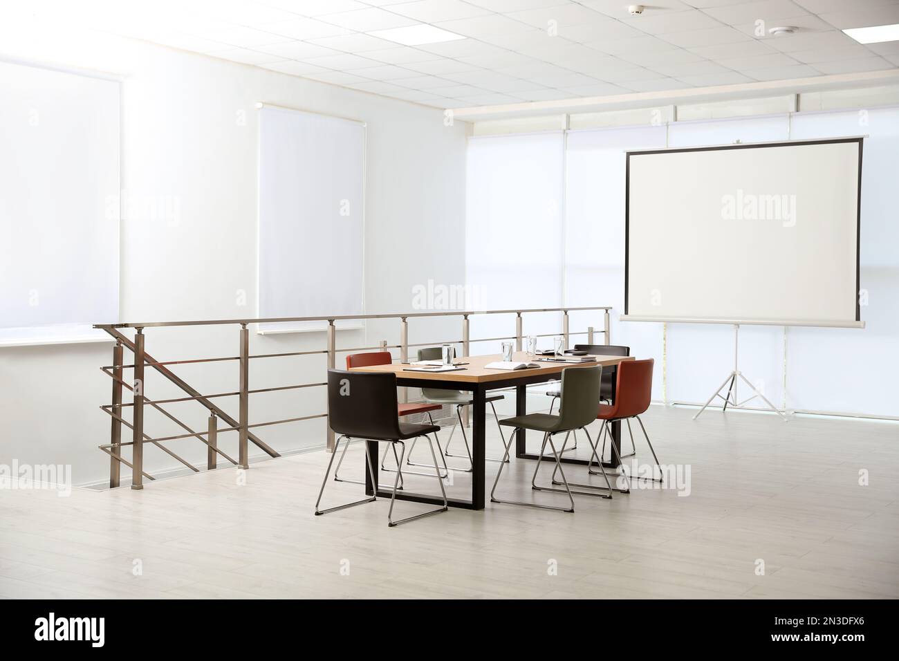Modern meeting room interior with large table and projection screen ...