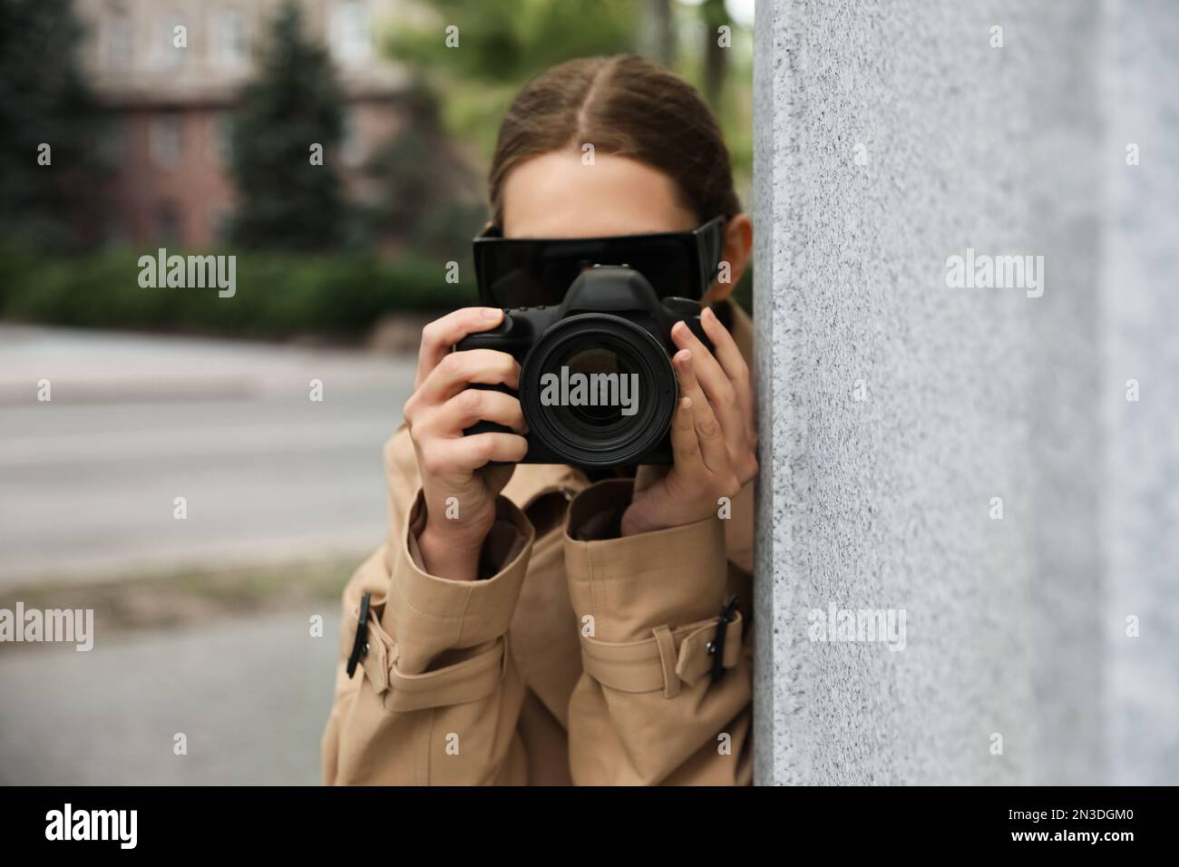 Private detective with modern camera spying on city street Stock Photo ...