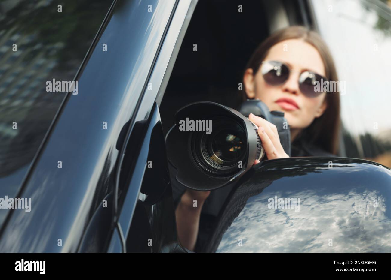 Private detective with camera spying from car, focus on lens Stock ...