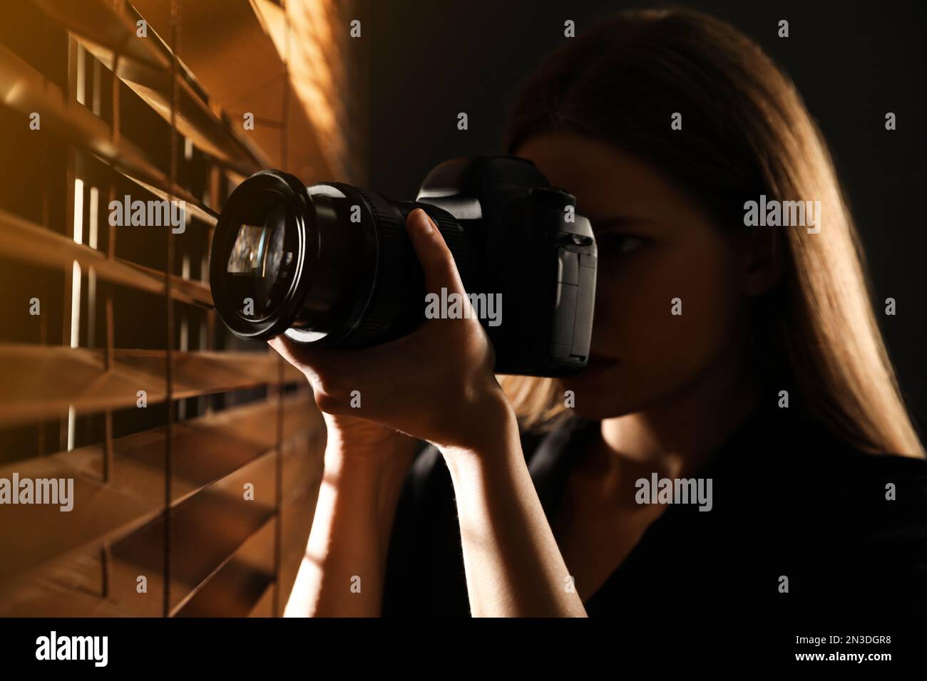Woman spying window hi-res stock photography and images - Alamy