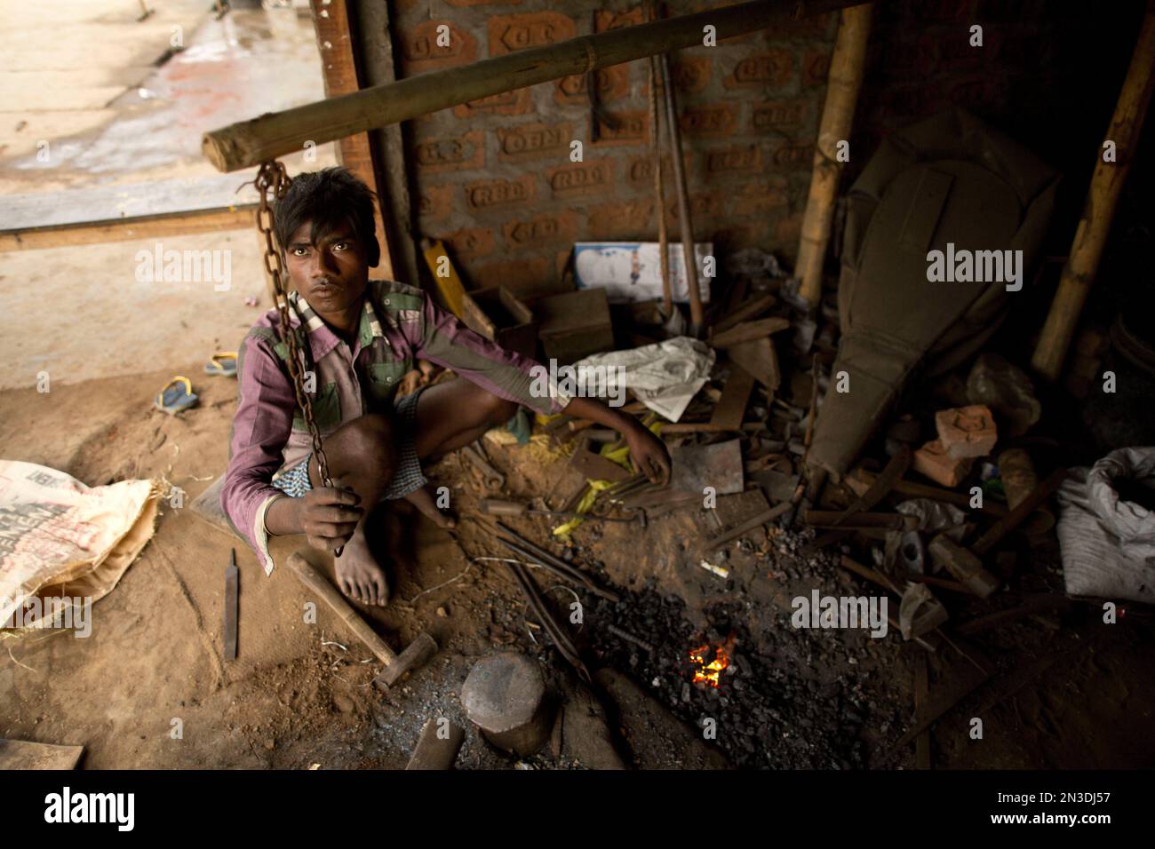 Samsher Ali, 14, works at a blacksmith workshop in Gauhati, India ...