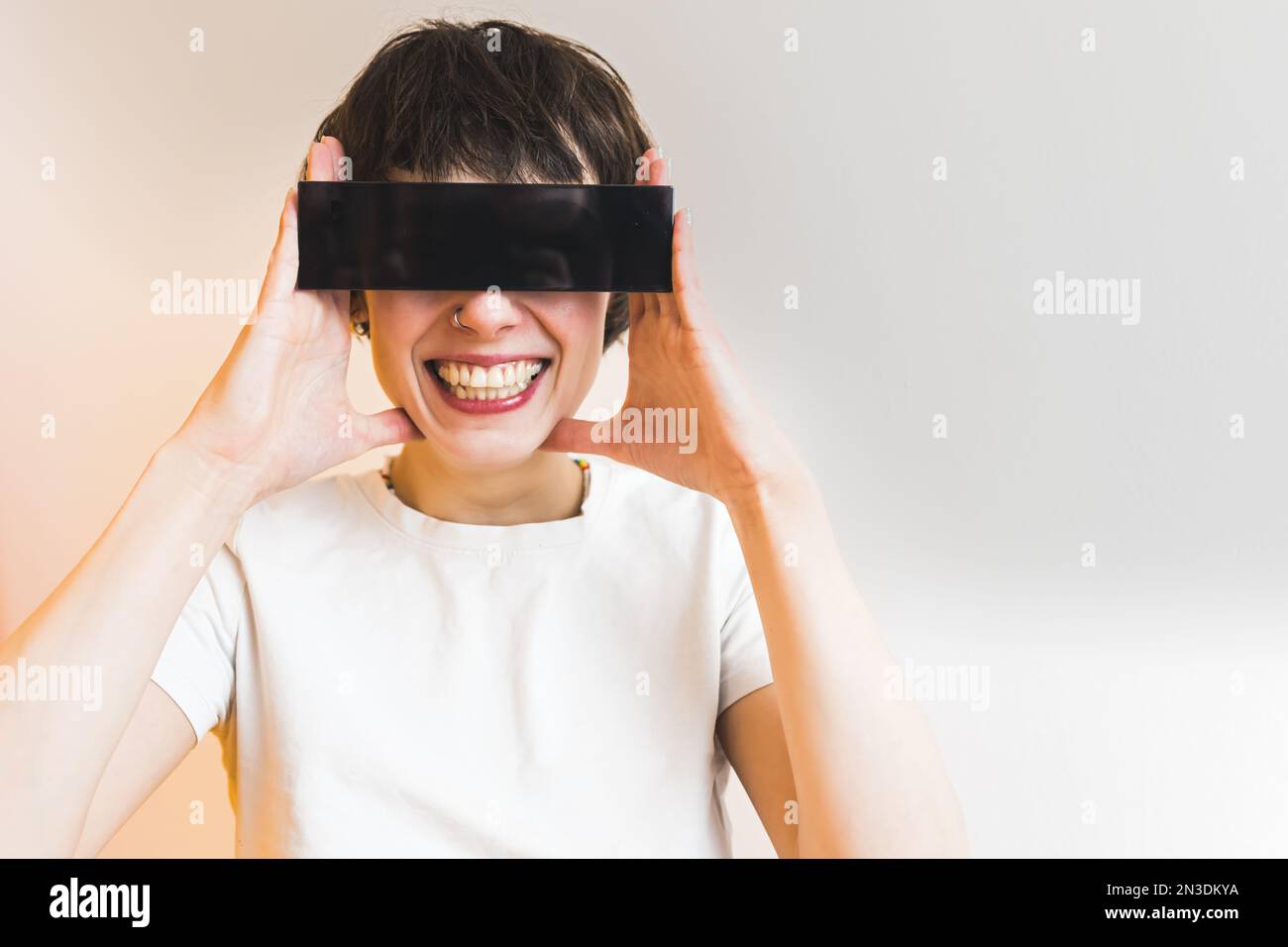 Fashionable eyewear concept. Short-haired female model smiling at ...