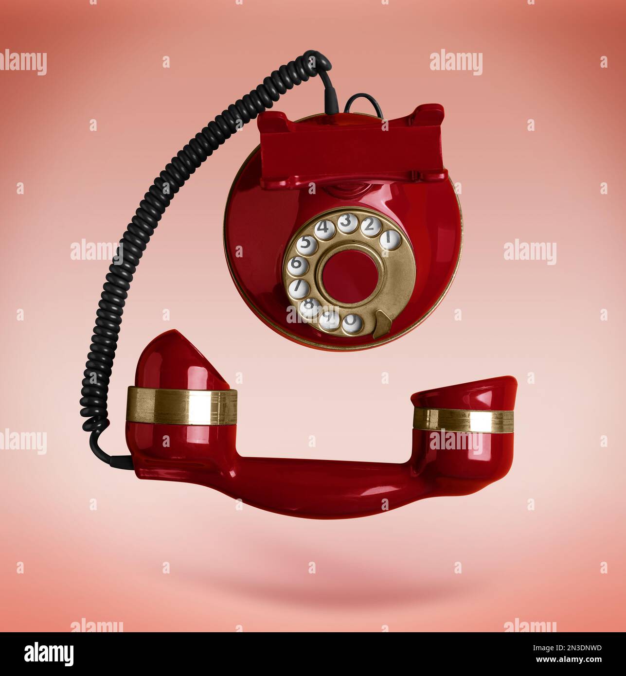 Vintage red corded telephone flying in air on color background Stock ...