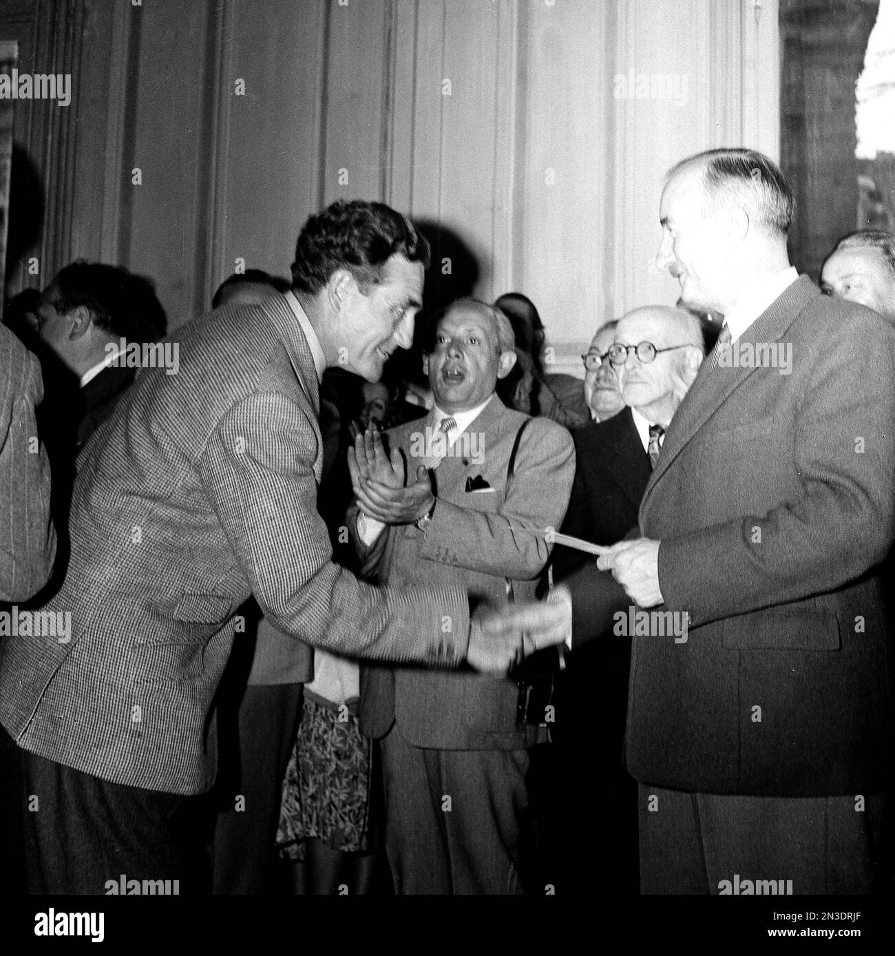 Briggs Cunningham, left, of Green Farms, Conn., accepts congratulations ...