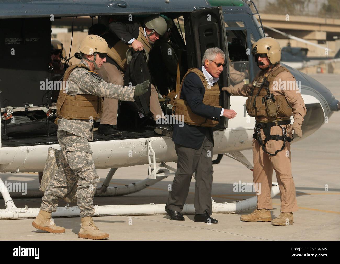 Defense Secretary Chuck Hagel, wearing body armor, steps off a ...