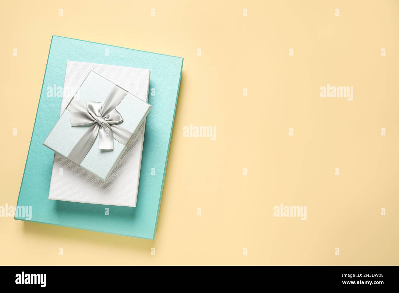 Beautiful gift boxes on beige background, top view. Space for text ...