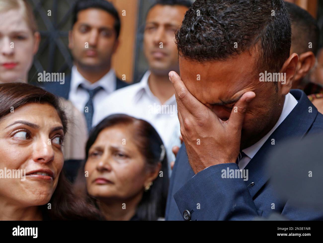 Ami Denborg, left, and her brother Anish Hindocha, right, react after ...