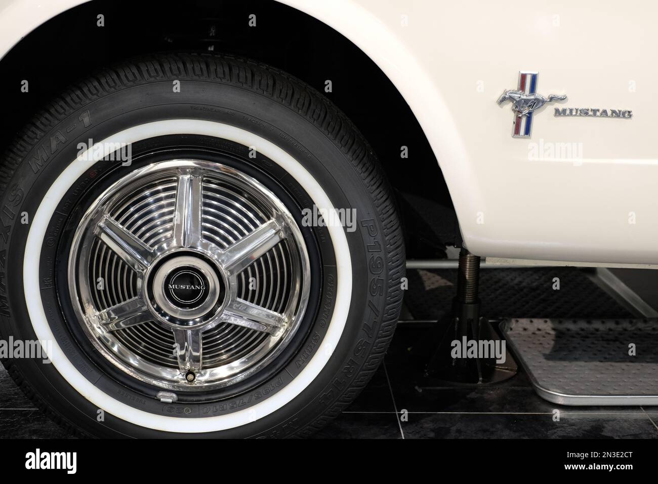 A closeup of the wheel of a white classic vintage car collected in the ...