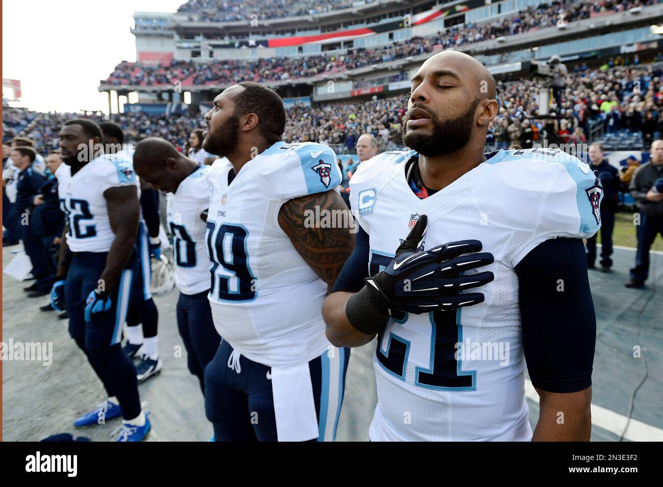 Tennessee Titans players, including safety George Wilson (21), stand ...