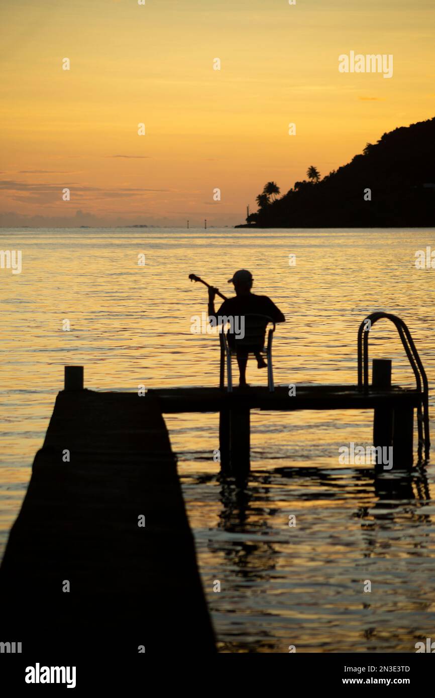 Man sitting on dock hi-res stock photography and images - Alamy