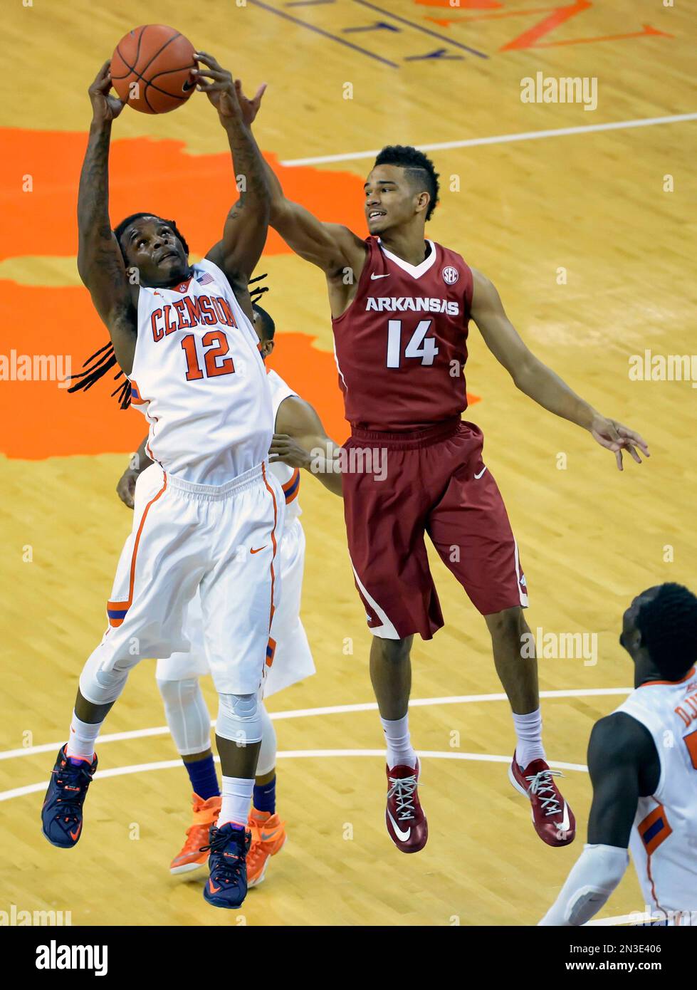 Clemson's Rod Hall (12) pulls down a rebound while pressured by ...