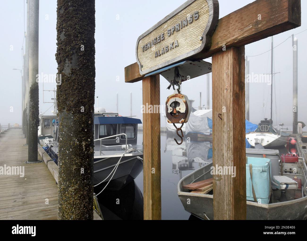 Boats line the dock at the small boat harbor in the village of Tenakee ...