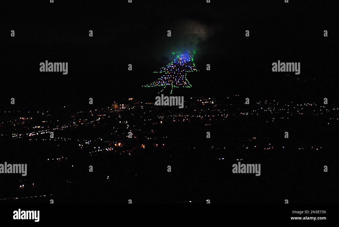 Lights form the outline of a Christmas tree on the slope of Mount ...