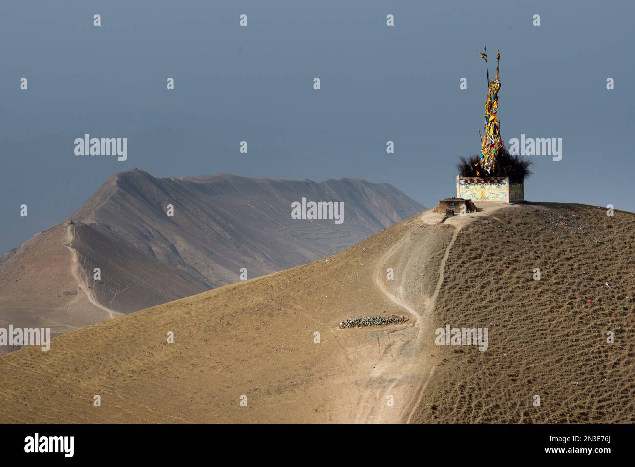 Tower of Buddhist prayer flags on a sandy mountaintop at Labrang ...