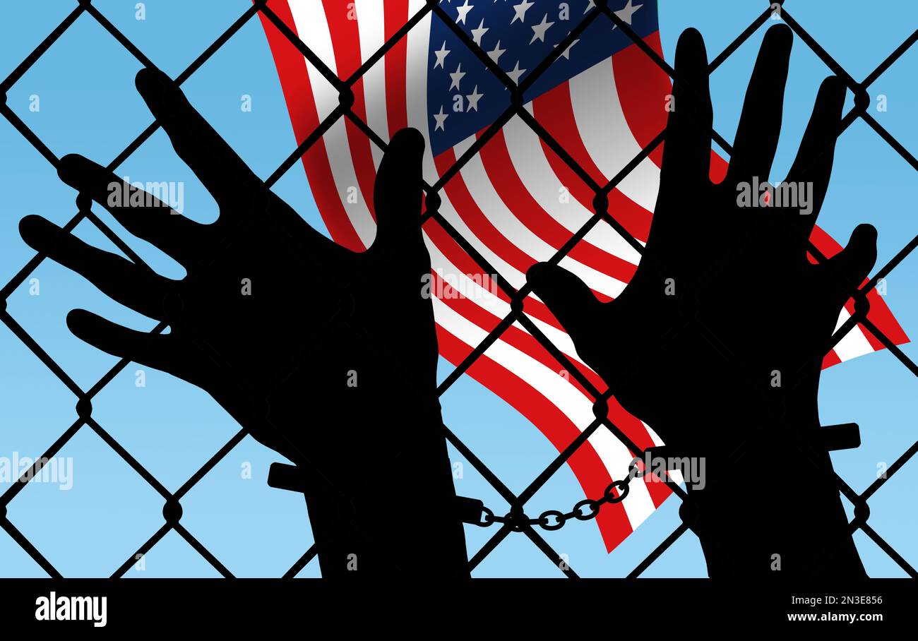 Hands in handcuffs rest on a chainlink fence with a USA flag in the ...