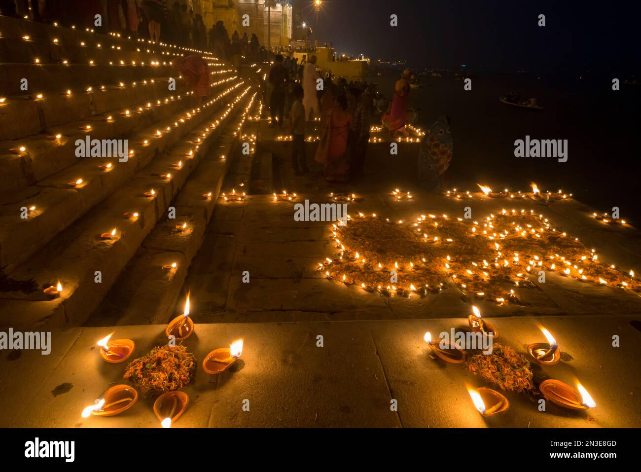 People gather at the ghats in Varanasi for Dev Deepawali with candles ...