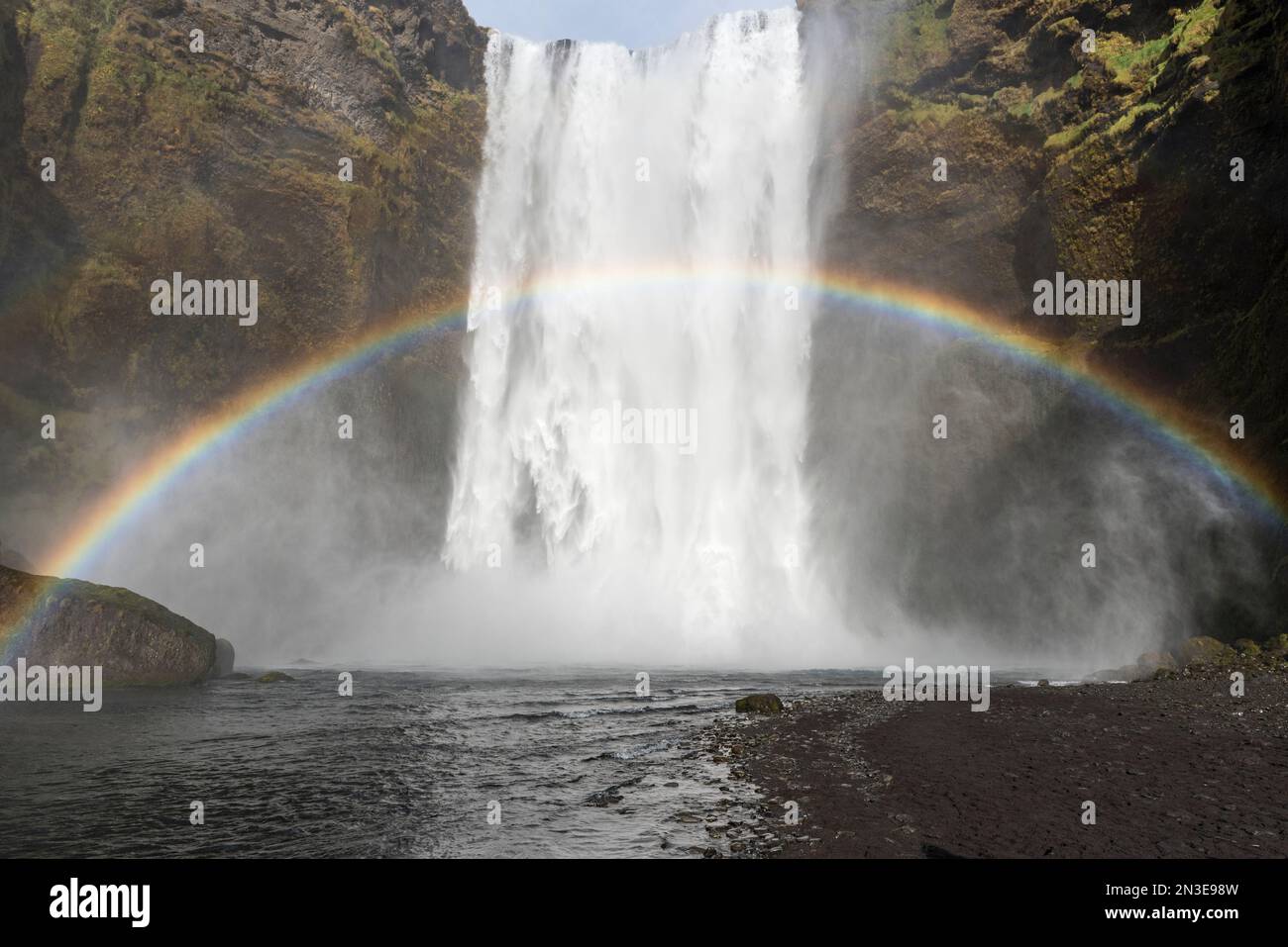 Cascading waterfall and rainbow; Iceland Stock Photo - Alamy