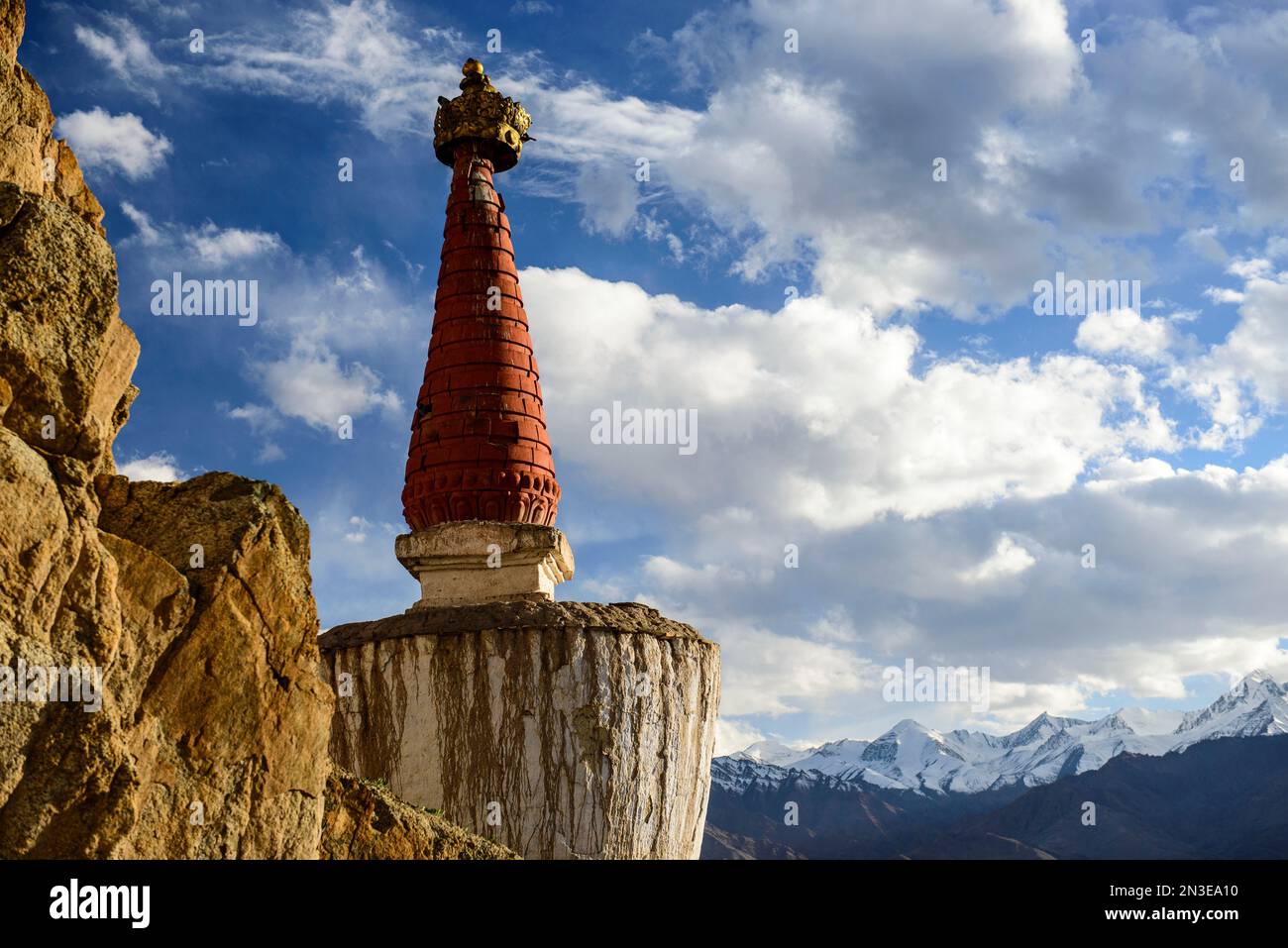 Close-up of a stupa of a Tibetan Buddhist gompa with snowy mountains in ...