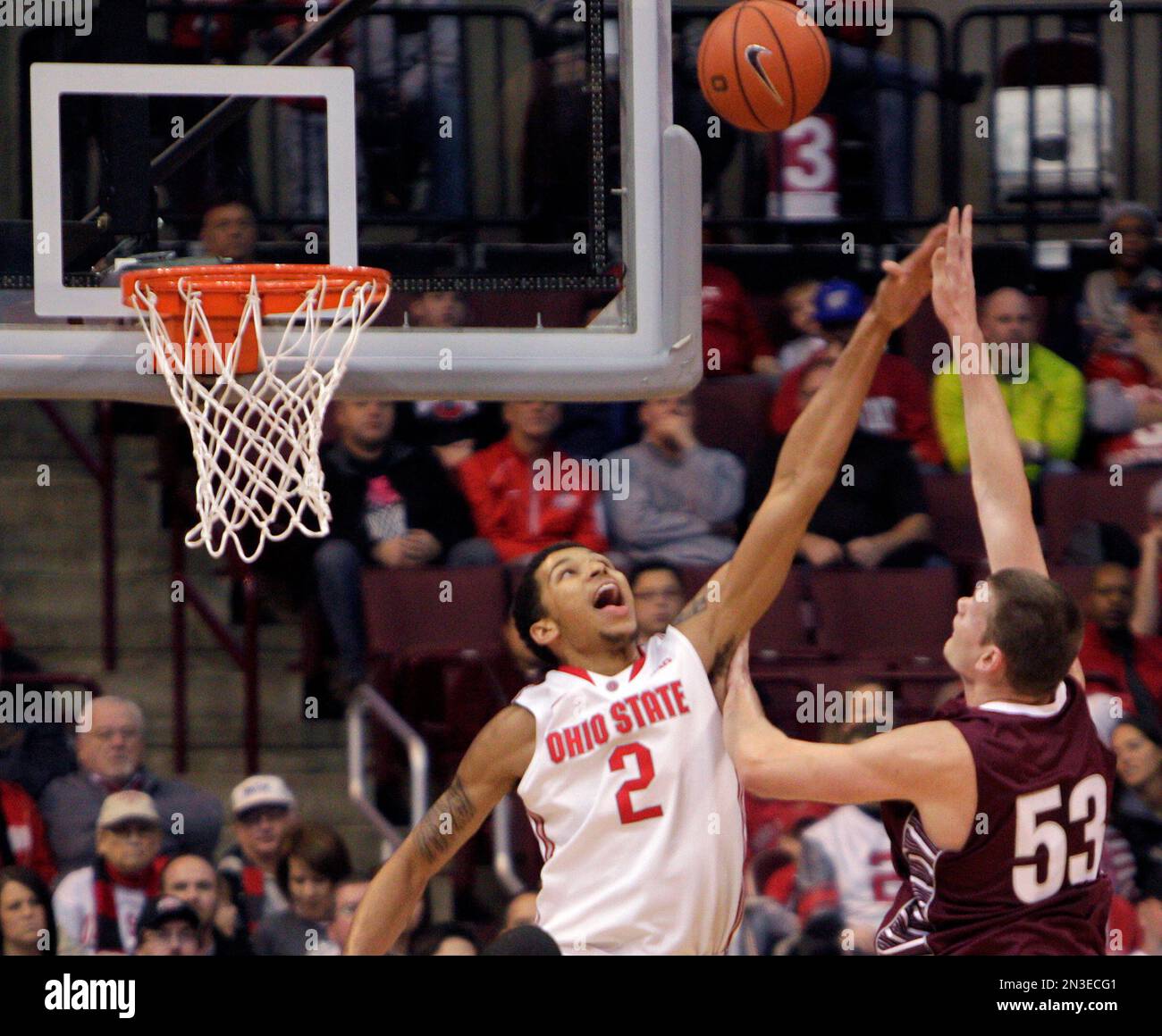Colgate's Ethan Jacobs, right, shoots over Ohio State's Marc Loving ...