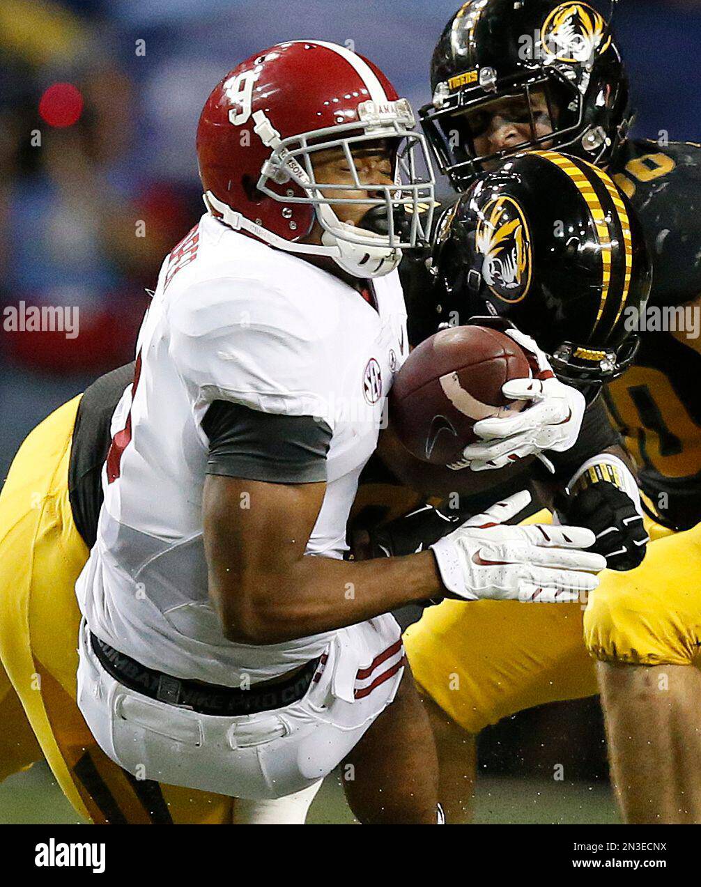 Alabama wide receiver Amari Cooper (9) is hit by Missouri defensive ...