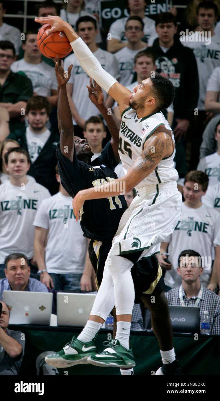 Michigan State's Denzel Valentine, right, blocks a shot by Arkansas ...