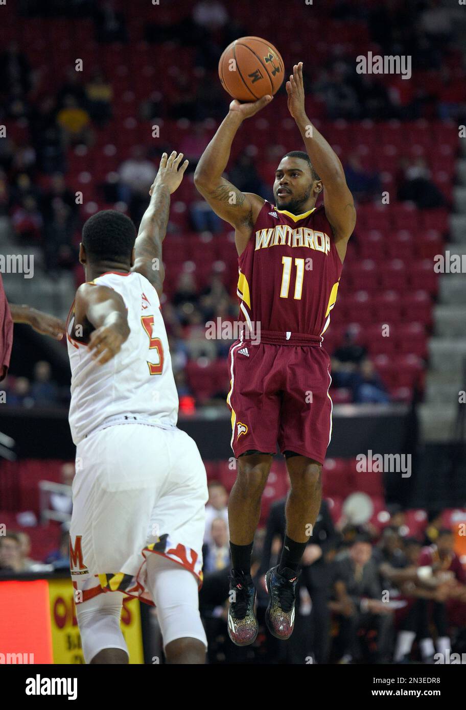 Winthrop guard Andre Smith (11) takes a shot against Maryland guard ...