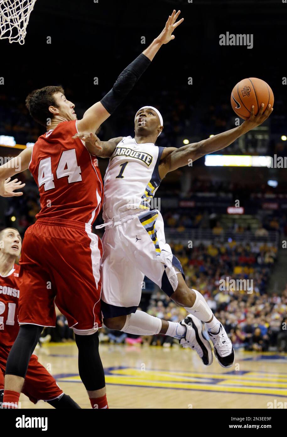 Marquette Golden's Duane Wilson, right, shoots against Wisconsin's ...