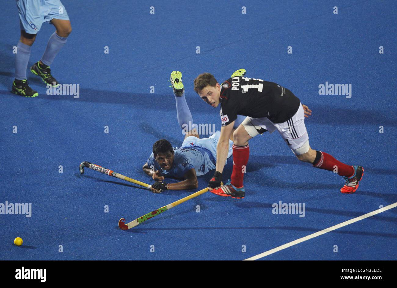 India's Birendra Lakra dives as he competes with Germany's Moritz Polk ...