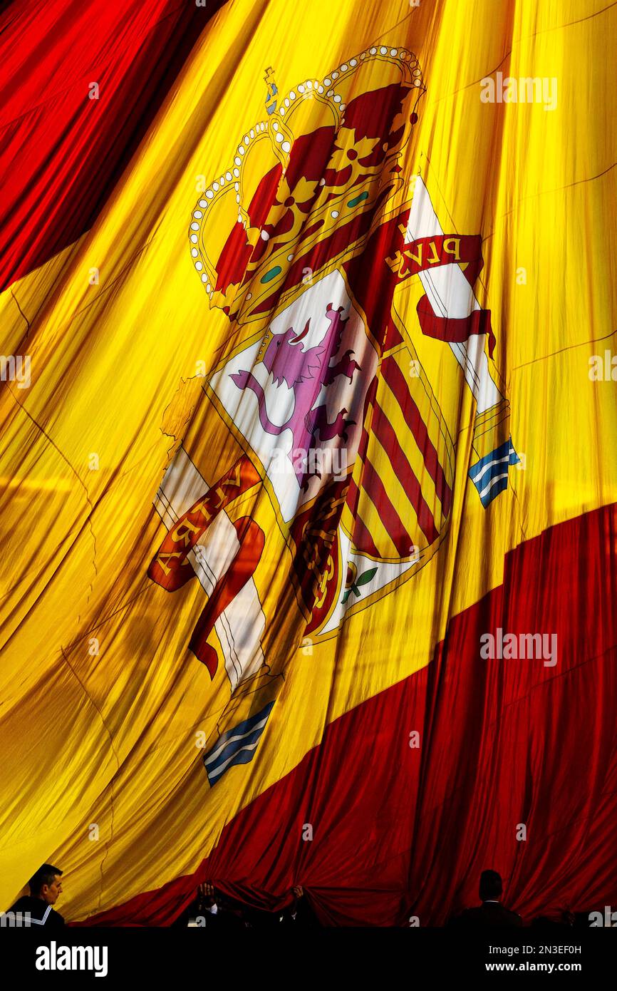 Spanish soldiers listen to the Spanish national anthem as they ...