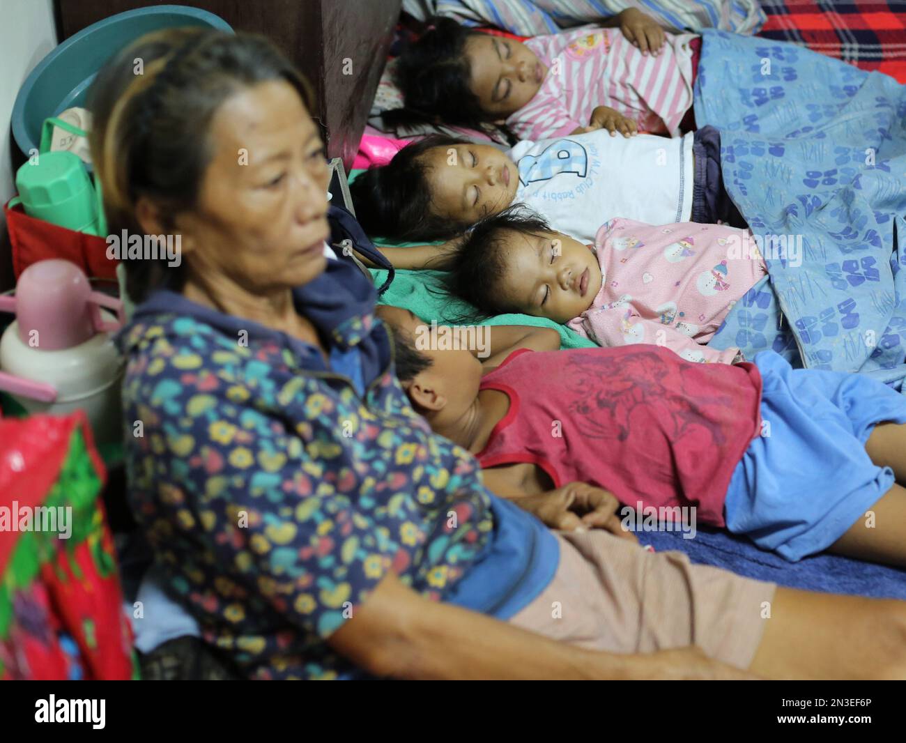Filipino children sleep as families seek refuge at a school used as an ...