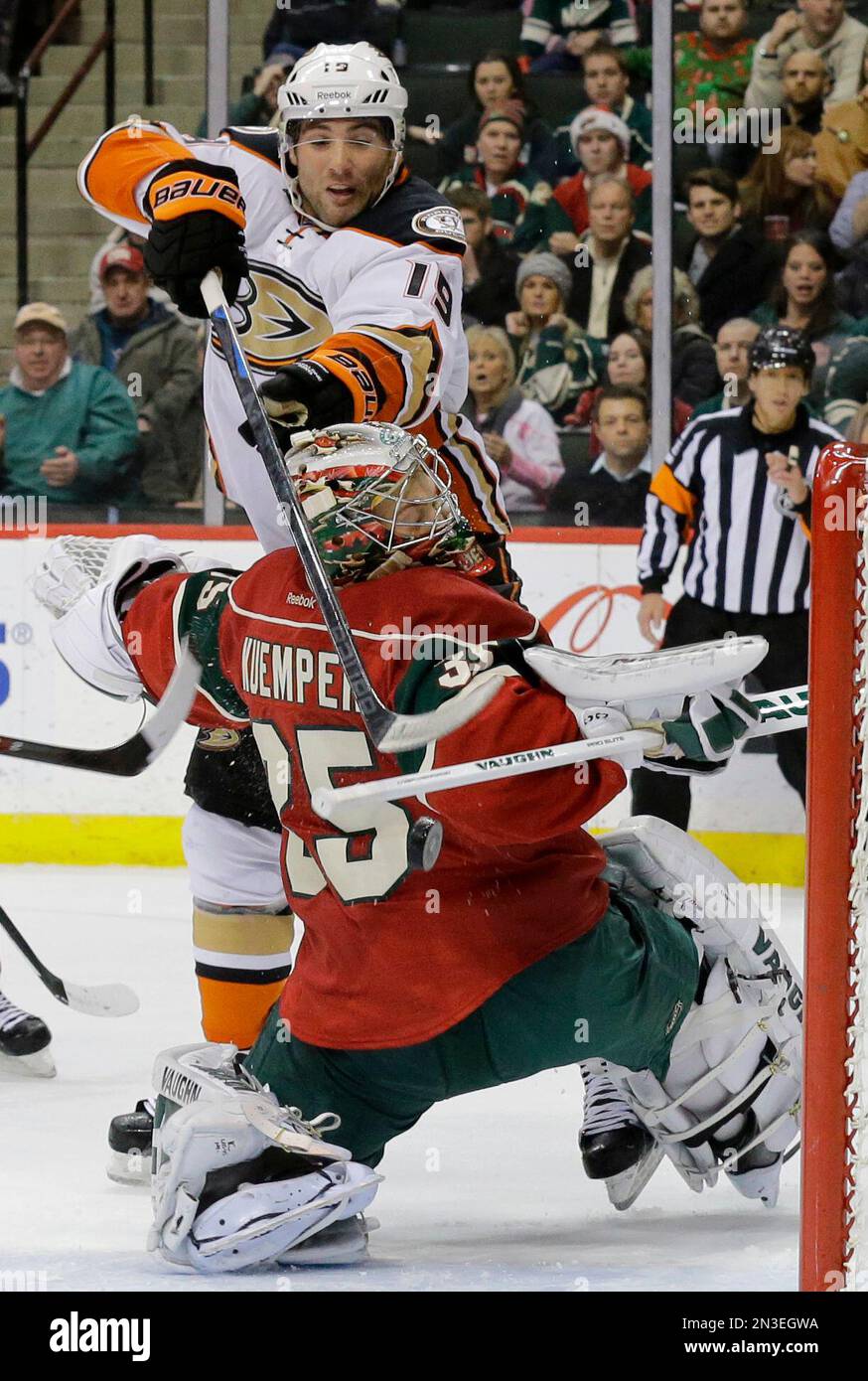 Anaheim Ducks left wing Patrick Maroon, top, reaches for the puck as he ...