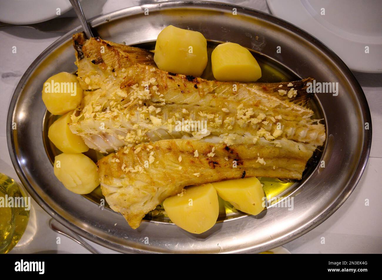 Grilled fillet of white codfish bacalhau served with potatos in fish ...