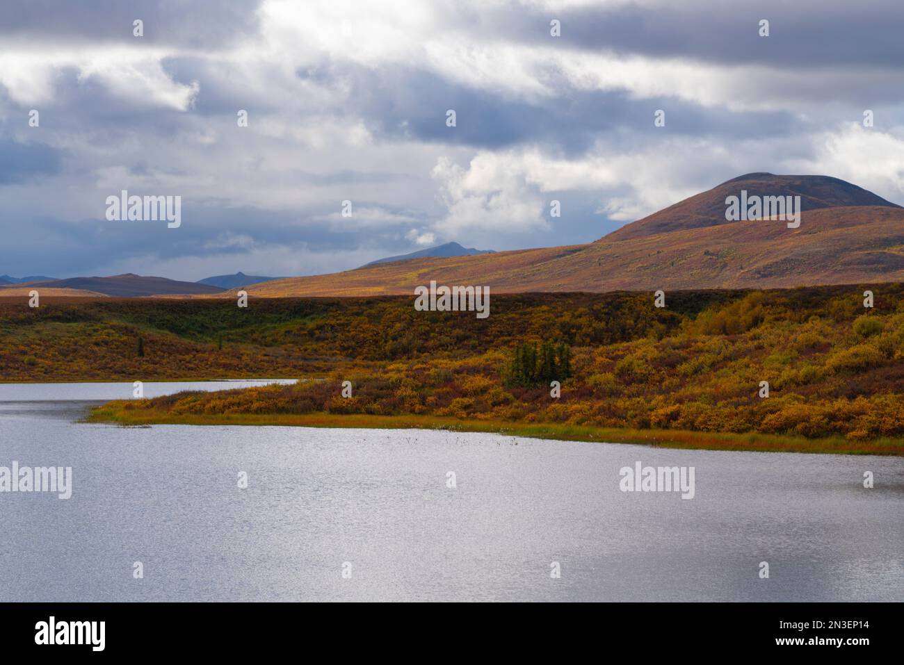 Two Moose Lake in autumn with fall colors while storm clouds clear out ...