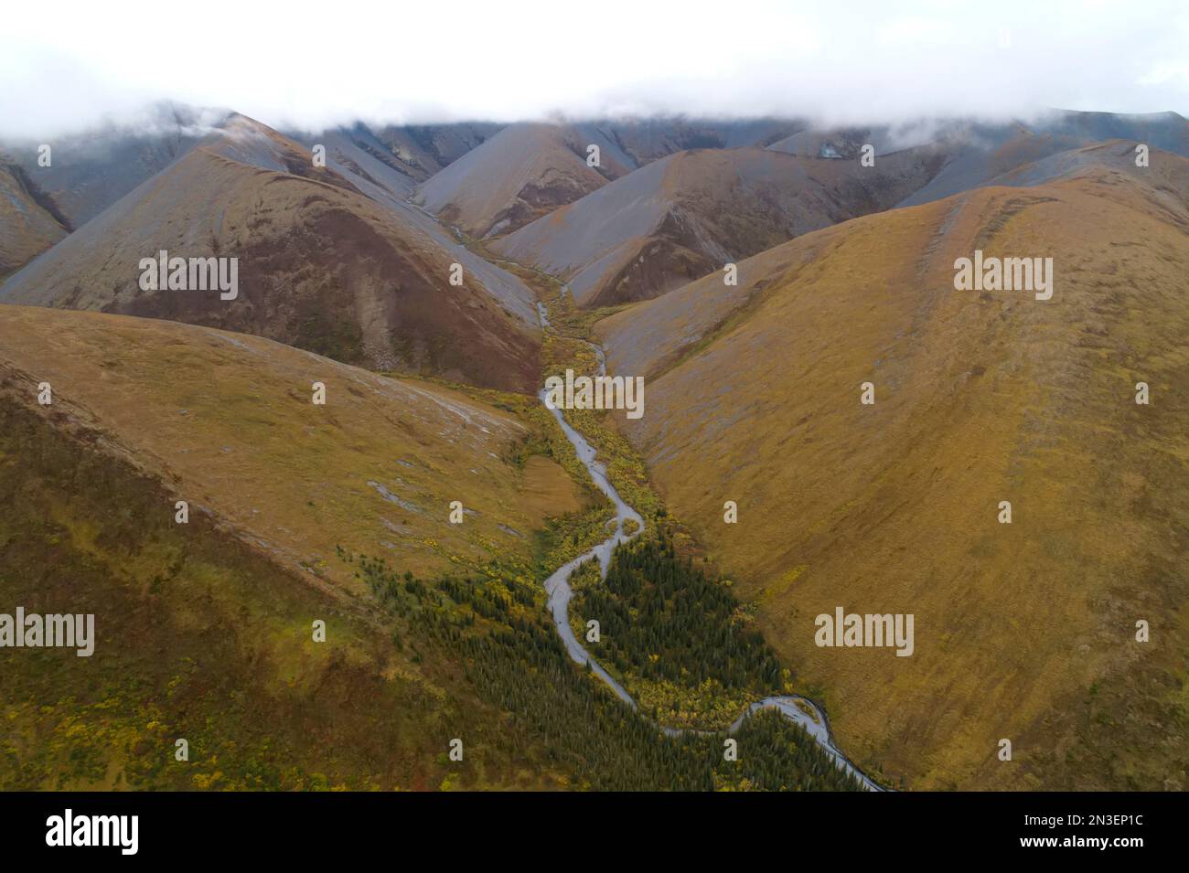 Aerial photograph of a river winding through the Richardson Mountains ...
