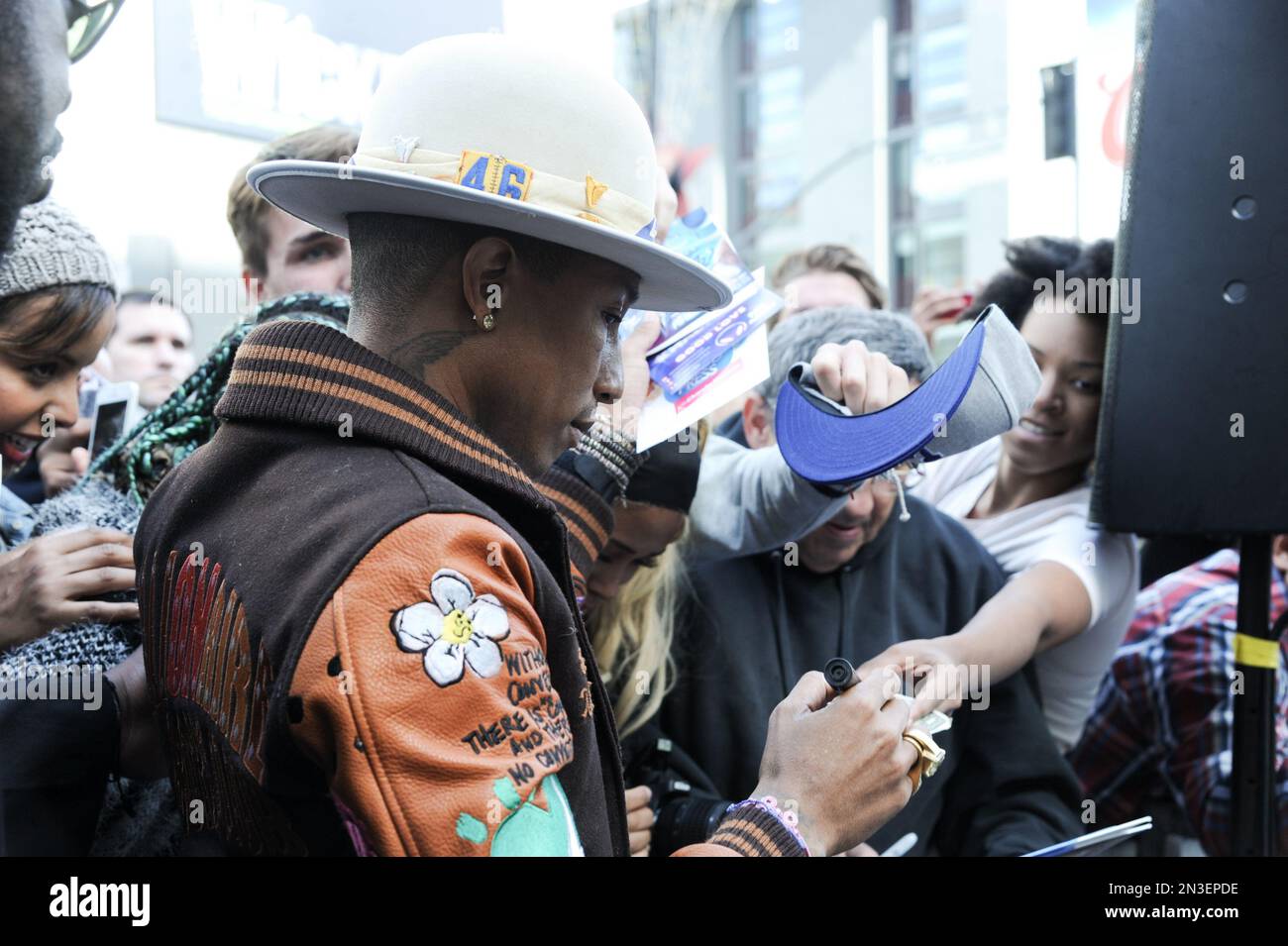 Pharrell Williams signs autographs for his fans after the ceremony ...