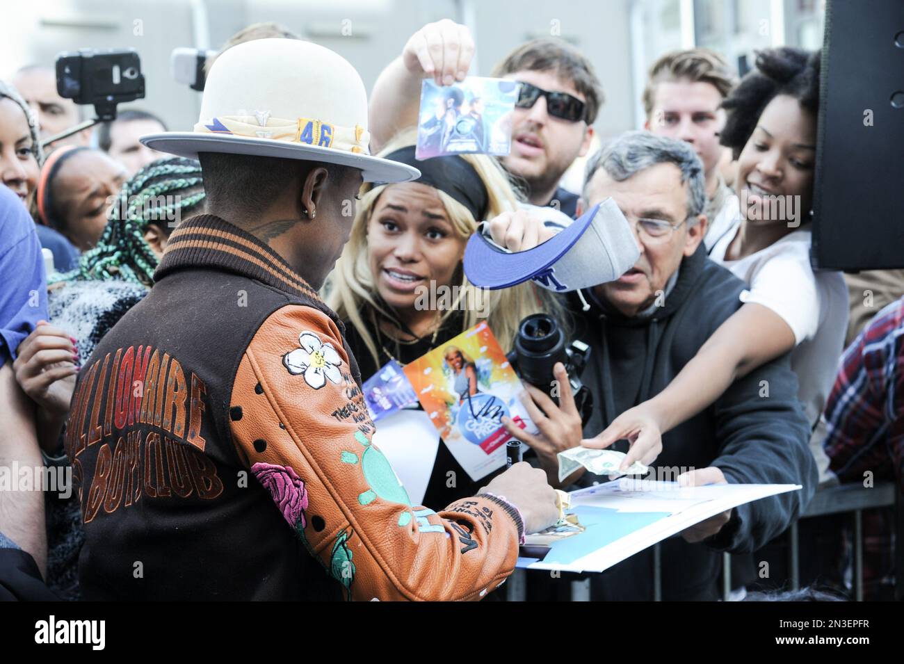 Pharrell Williams signs autographs for his fans after the ceremony ...