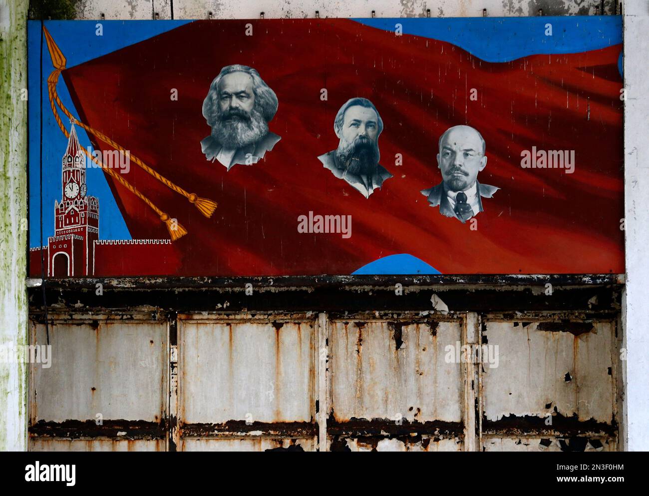 In this photo taken Friday, Nov. 7, 2014 a mural depicting Communist ...