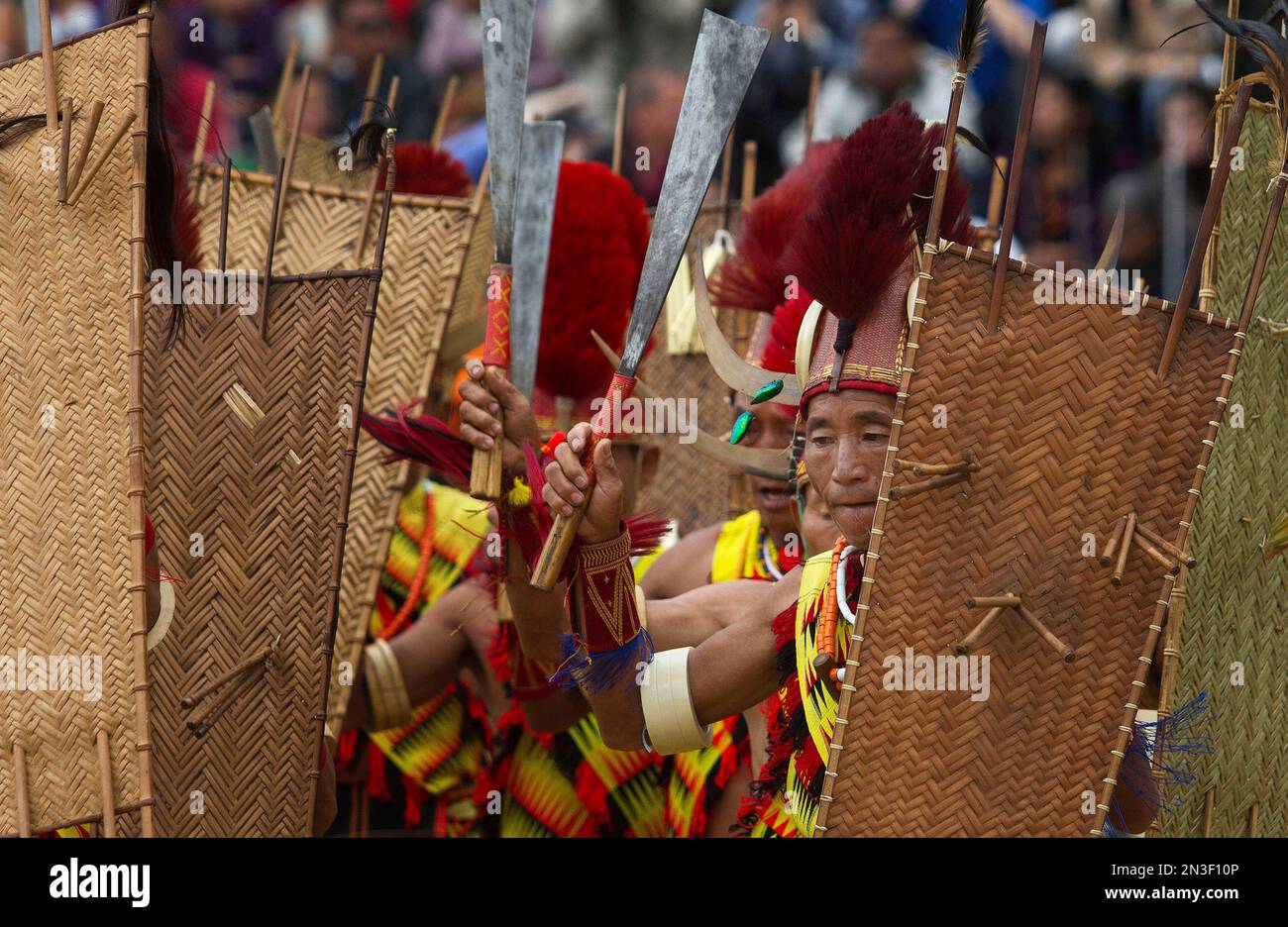 Naga tribal men in traditional attire perform a folk dance during the ...