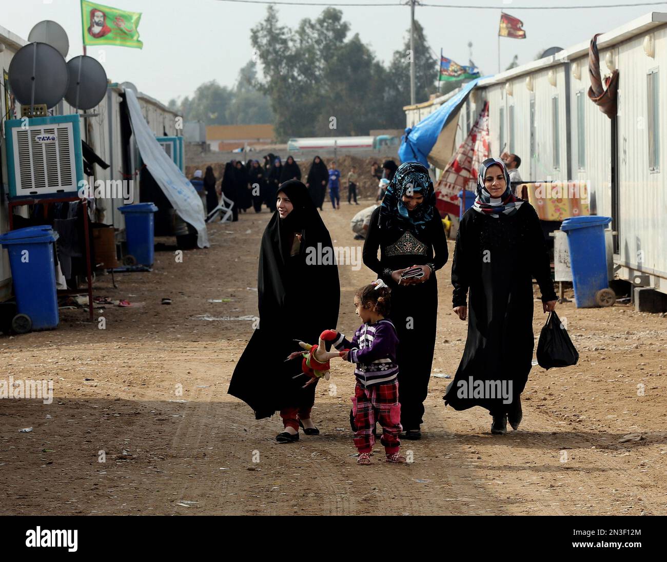 In this Thursday, Nov. 27, 2014 photo, Huda Mohammed, right, a Shiite ...
